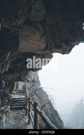 Misty cliffside stairway on Songshan Mountain in black & white Stock ...