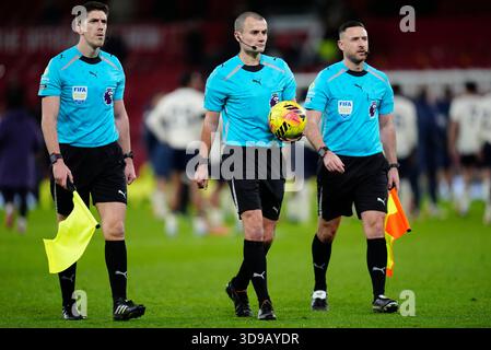 Referee Andrew Kitchen (centre left) shows Wrexham's Ryan Longman ...