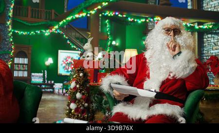 Santa Claus shushing Stock Photo - Alamy