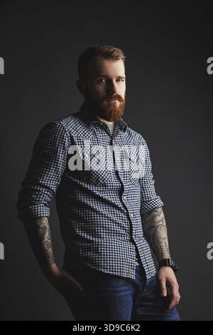 Serious handsome man in checked shirt keep raised finger pointing up ...