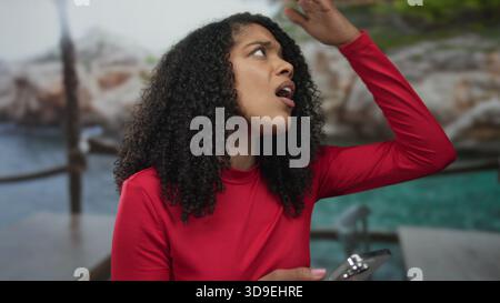 Female tapping on a cellphone at the railing Stock Photo - Alamy