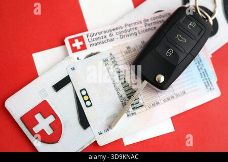 Switzerland car license plate and ignition key on Swiss flag close up ...