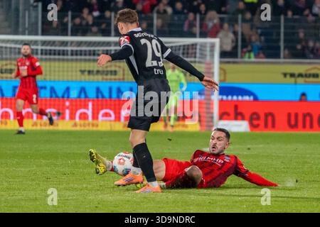 Tackle between Arijon Ibrahimovic (FC Heidenheim, #22) and David Raum ...