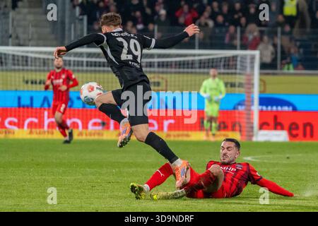 Tackle between Arijon Ibrahimovic (FC Heidenheim, #22) and David Raum ...