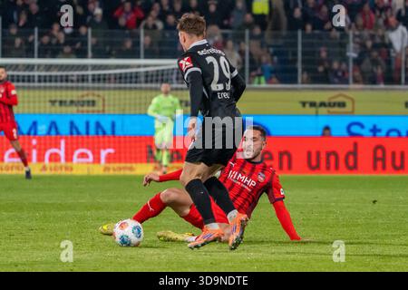 Tackle between Arijon Ibrahimovic (FC Heidenheim, #22) and David Raum ...
