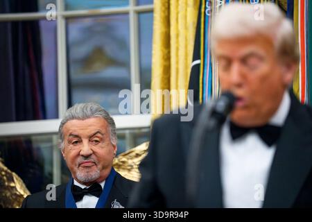 Sylvester Stallone looks on after President Donald Trump, foreground ...