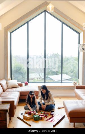 Colored ribbons, gift boxes, wrapping paper on a wooden table ...