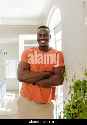 Standing man wearing beige-tee teal-shorts holding padel racket at blue ...