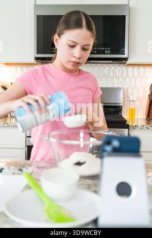 Child adding ingredients to a mixing bowl Stock Photo - Alamy