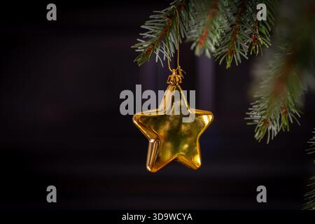 Golden baubles hanging on tree. Christmas town decoration Stock Photo ...