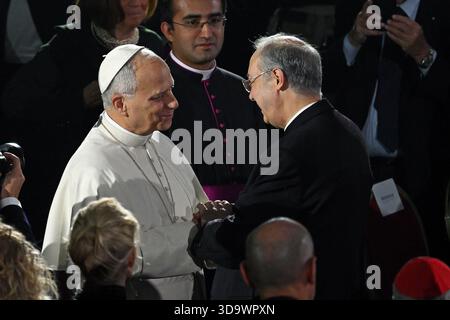 Pope Leo XIV shakes hands with Monsignor Rino Fisichella, right, as he ...