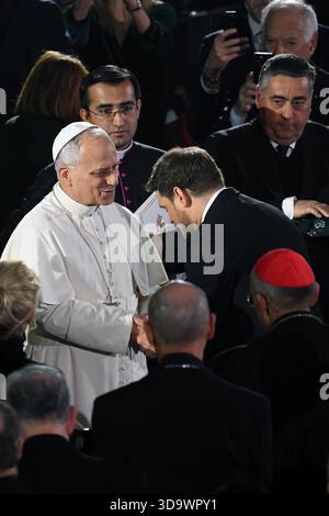 Pope Leo XIV shakes hands with Monsignor Rino Fisichella, right, as he ...