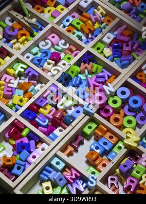 Pile of beads or letter bead with alphabet and little tree on white ...