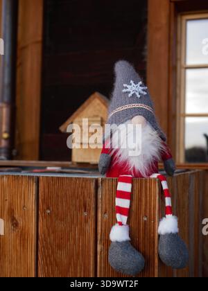 Christmas gnome in a striped hat with a heart in his hands. Decoration ...