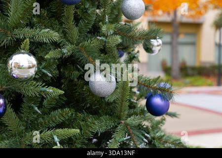 Silver Christmas ornaments in leaves Stock Photo - Alamy