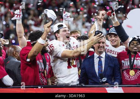 Indiana quarterback Fernando Mendoza holds the Heisman Trophy during an ...