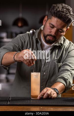 Professional cocktail tools and ingredients in glass bottles and jars ...