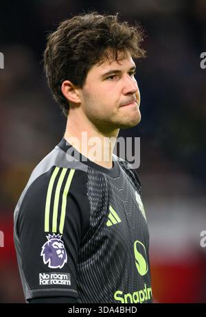 Manchester United's goalkeeper Senne Lammens punches out the ball ...