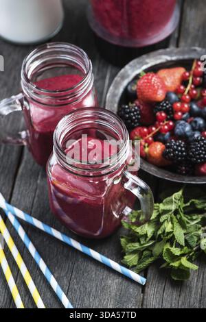 Mason jar with tasty berry smoothie on table Stock Photo - Alamy