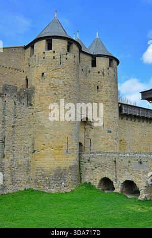 The medieval walls with hordings, bridge over moat and towers of the ...