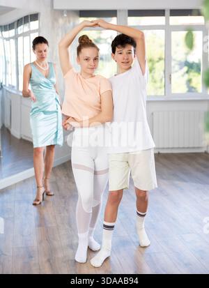 Teen girl dancing in ballroom dress, isolated on yellow background ...