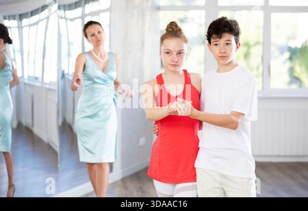 Passionate teen dancers, girl and boy practicing ballroom dancing in ...