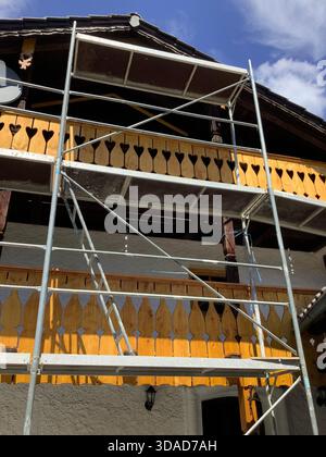 Wooden scaffold on house, renovation. Scaffolding on building, wall and ...