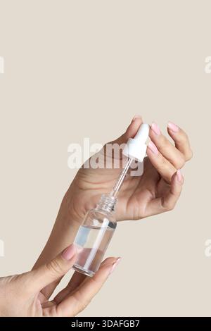 Serum glass transparent bottle with pipette on stone surface. Natural ...