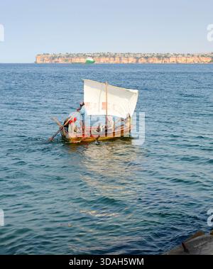 LUANDA, ANGOLA - FEB 03, 2025: People on a sail boat in the sea near ...
