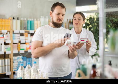 Man buyer scans paracetamol qr code with woman pharmacist Stock Photo ...