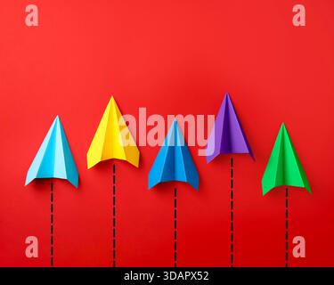 Red and green paper planes on pink background Stock Photo - Alamy