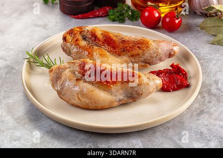 Roasted rabbit leg served rosemary in the plate Stock Photo - Alamy