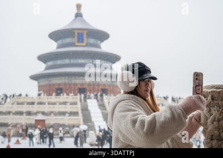 Tourists visit the Tiantan Park amid hot weather in Beijing, China ...