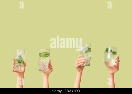 Female hands with different glasses of mojito on green background Stock ...
