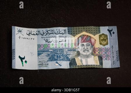 Omani rial banknotes denominations arranged on dark background, showing ...