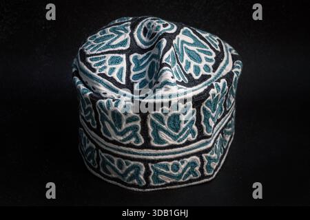 Traditional Omani cap with intricate turquoise and white embroidery ...