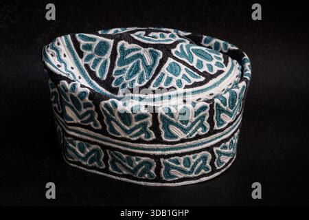 Traditional Omani cap with intricate turquoise and white embroidery ...