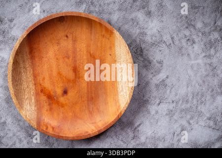 Empty wooden plate on concrete table. Wood plate for food. Flat lay ...