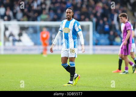 David Kasumu #18 of Huddersfield Town competes for the ball with Ben ...