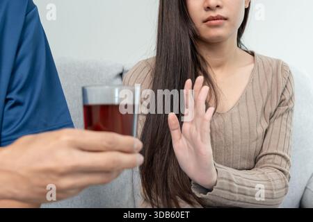 woman refuses say no and avoid to drink an alcohol whiskey, stopping ...