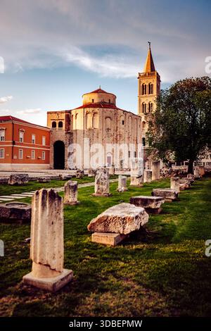 Ancient stone tower and weathered column under a vibrant blue sky with ...