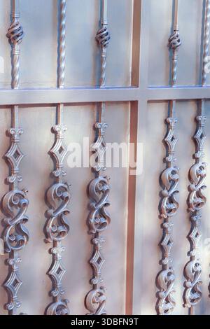 Shiny metal railing barrier fence stand on concrete footpath beside ...
