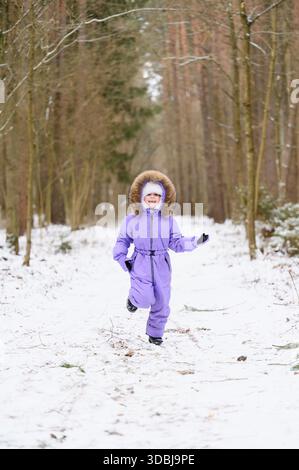 cute girl walks through a snow-covered forest in winter Stock Photo - Alamy