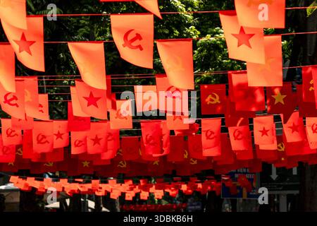 Flags bearing the hammer and sickle symbol are flown in front of ...
