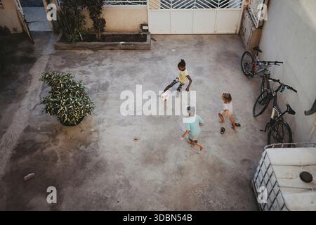 Children playing football in a courtyard Stock Photo - Alamy