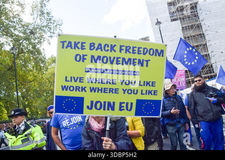 A protester holds a 'Take back freedom of movement' placard on Waterloo ...