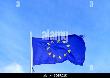 Waving European Union flag on blue sky Stock Photo - Alamy