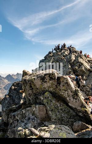 The summit of Rysy, Poland's highest mountain, with numerous hikers and ...