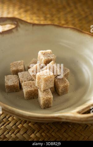 Brown colored,sugar cubes on kraft paper with grain of sugar and copy ...