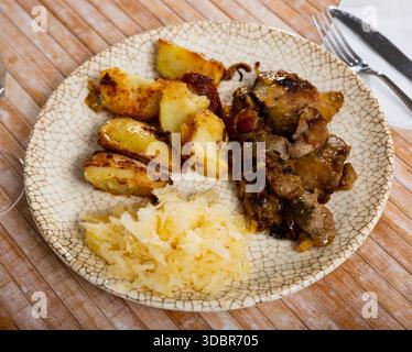 Rabbit liver dish with boiled potatoes and sauerkraut closeup Stock ...